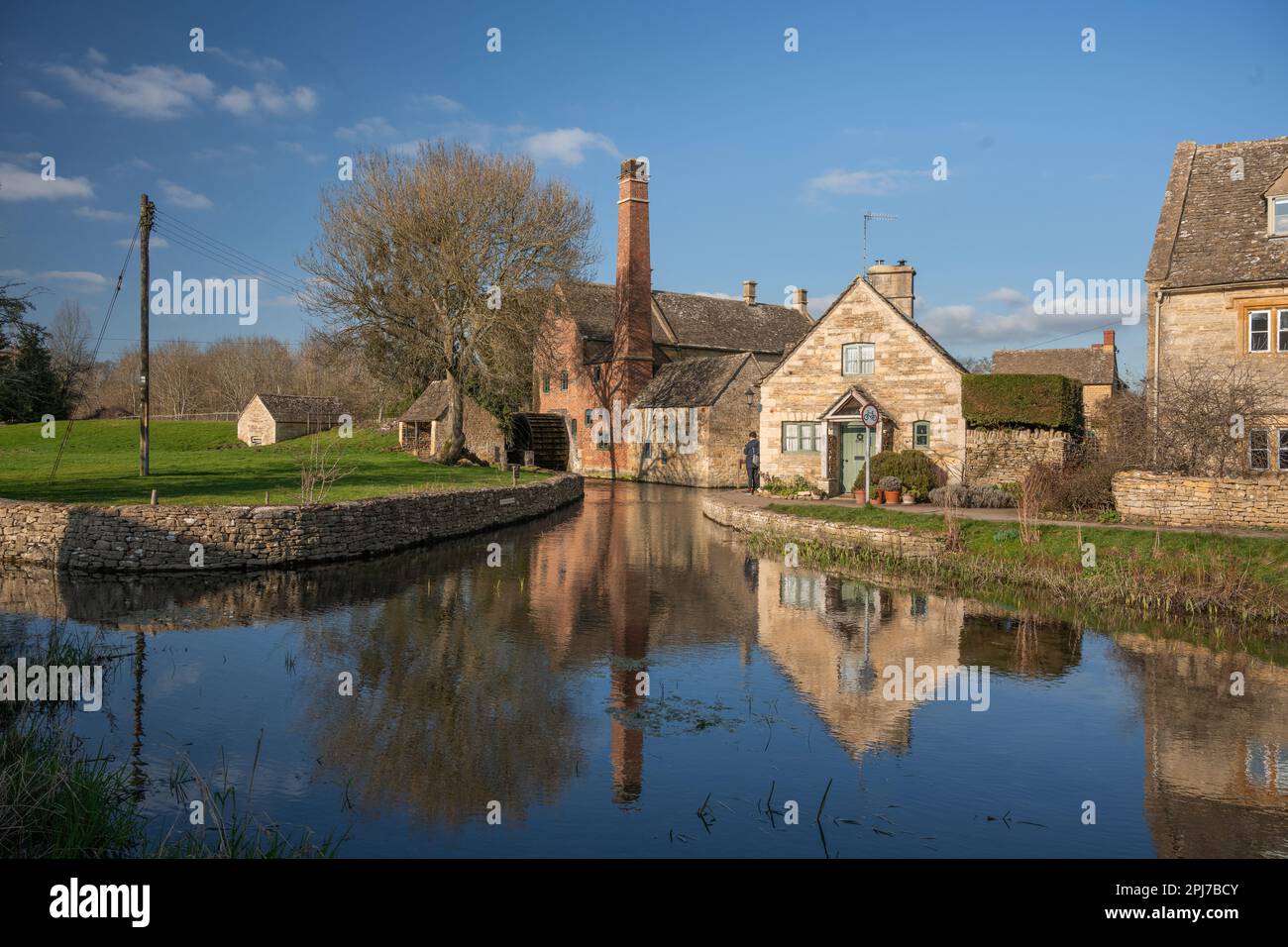 Iconic medieval built house with green wooden door in Lower Slaughter ...