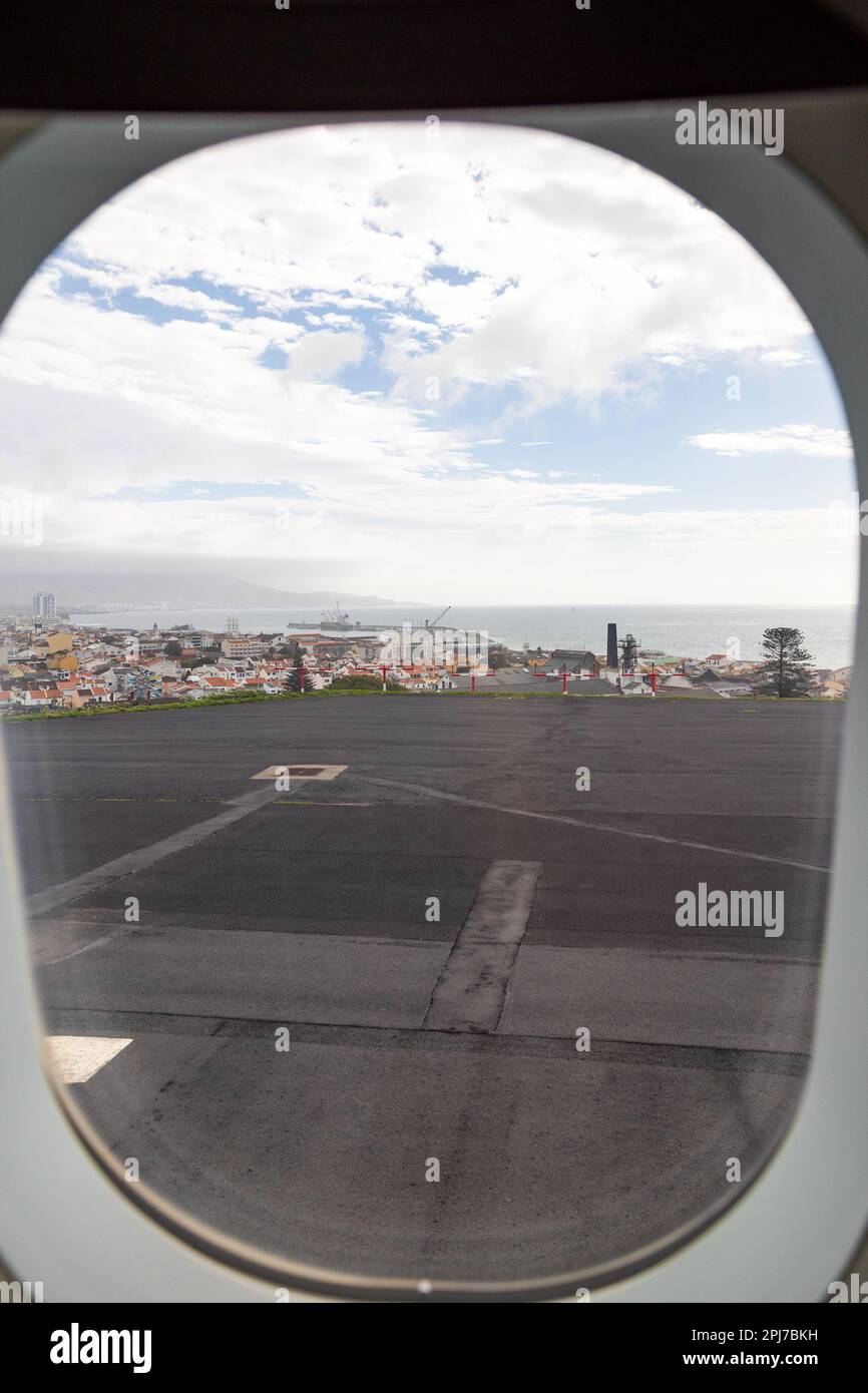 View from plane window, houses, clouds and runway Stock Photo - Alamy