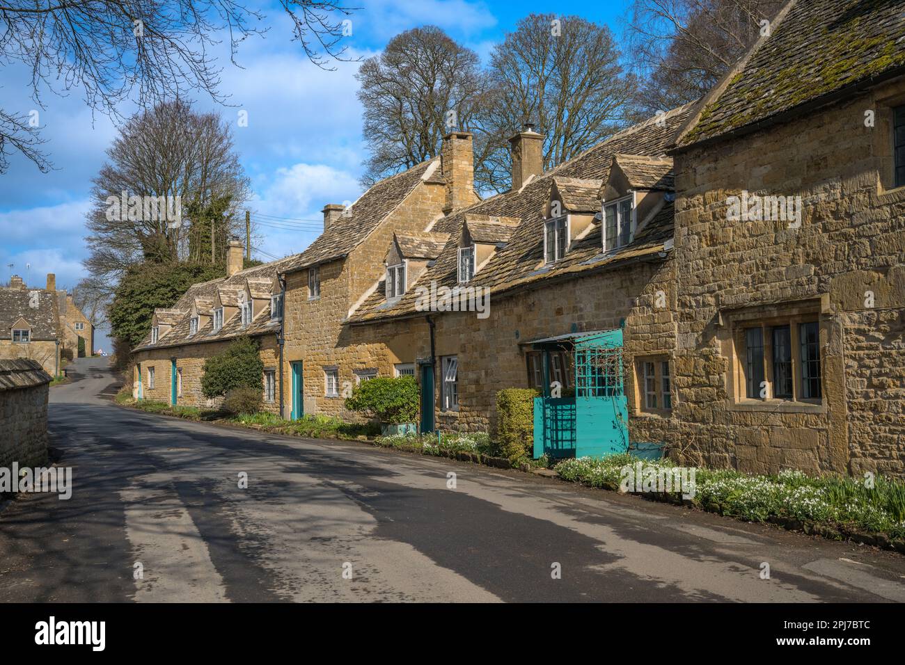 Iconic row of medieval stone built cottages in the picturesque village ...