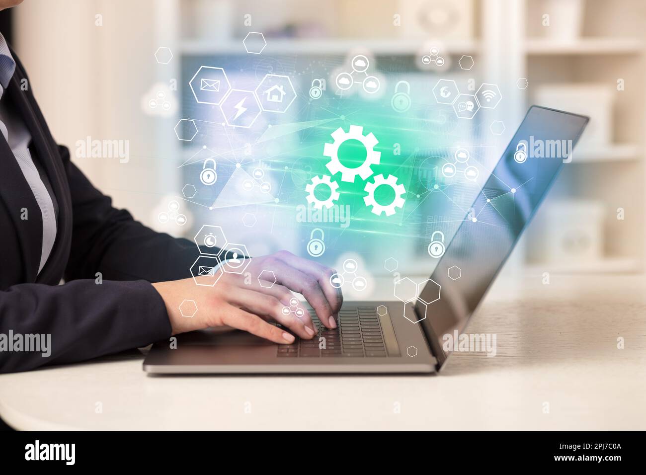 Hands working on laptop with digital icons Stock Photo - Alamy
