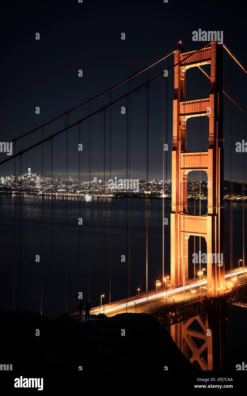 Vertical portrait of the Golden Gate bridge at night with the city of ...