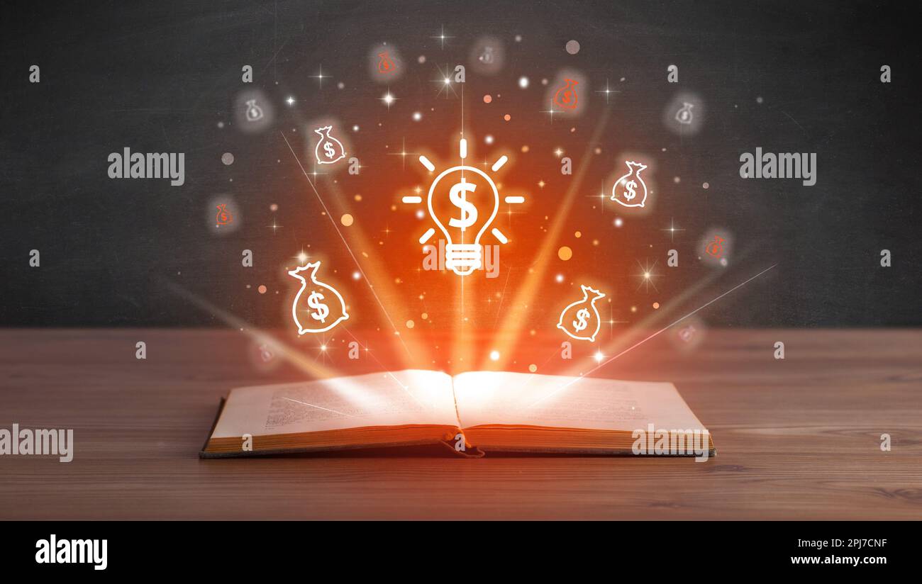 Open book with currency icons above Stock Photo - Alamy