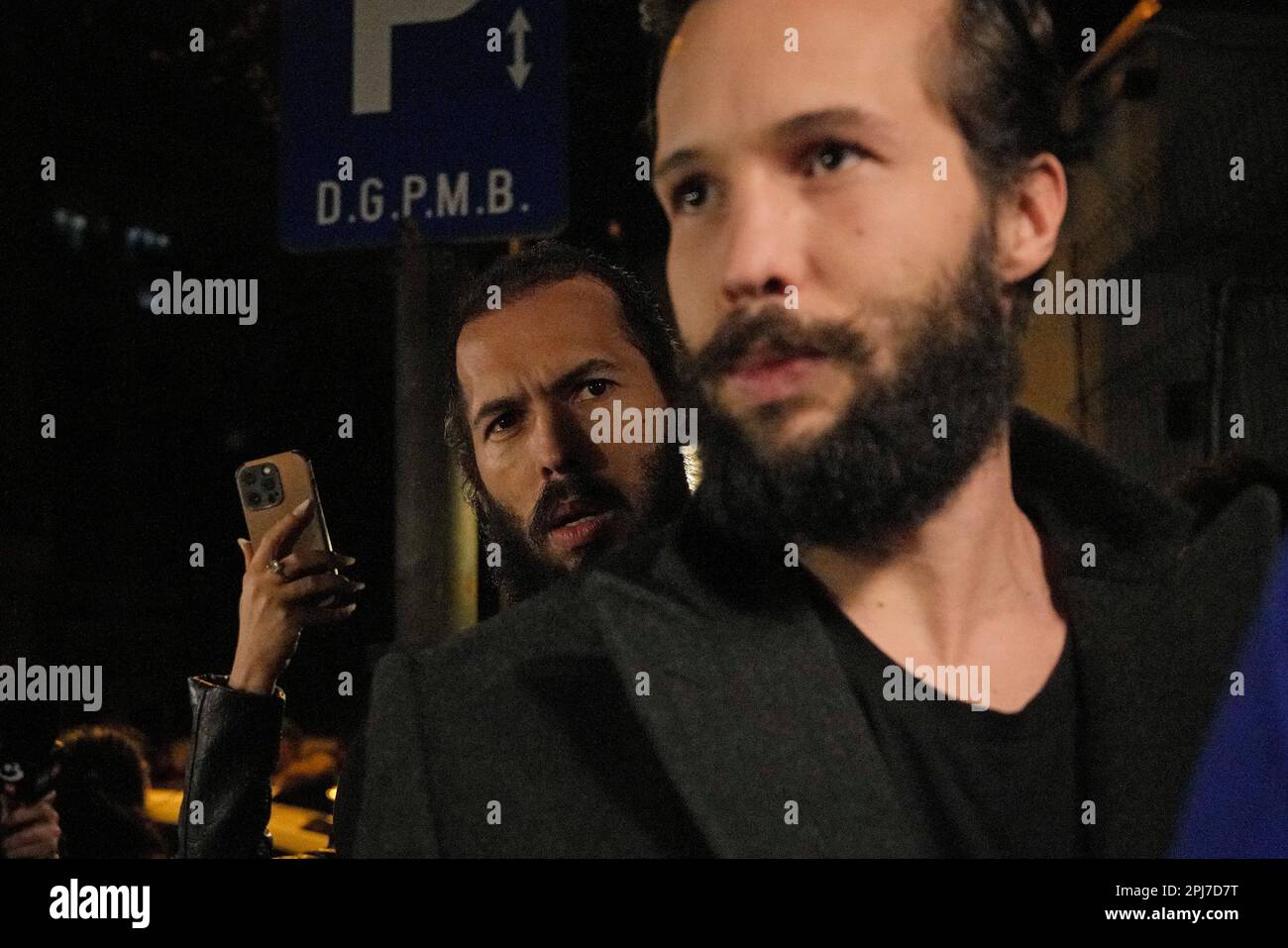 Andrew Tate, left, and his brother Tristan are driven from a police ...