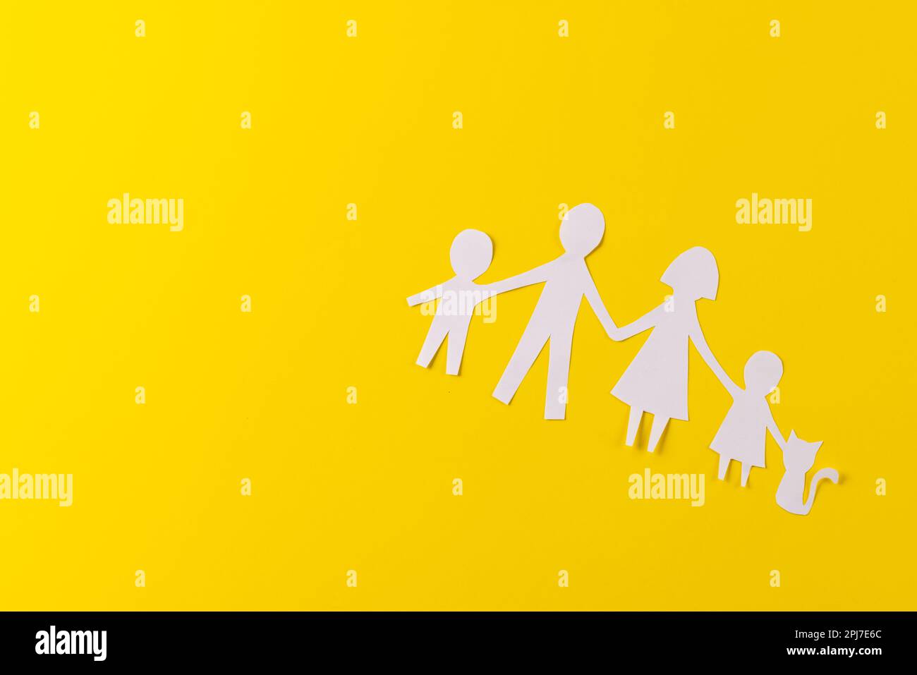 White paper cut out of family with two children and ca and copy space ...