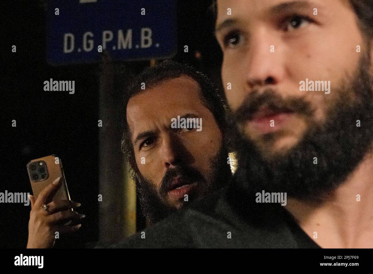 Andrew Tate, left, and his brother Tristan leave a police detention ...