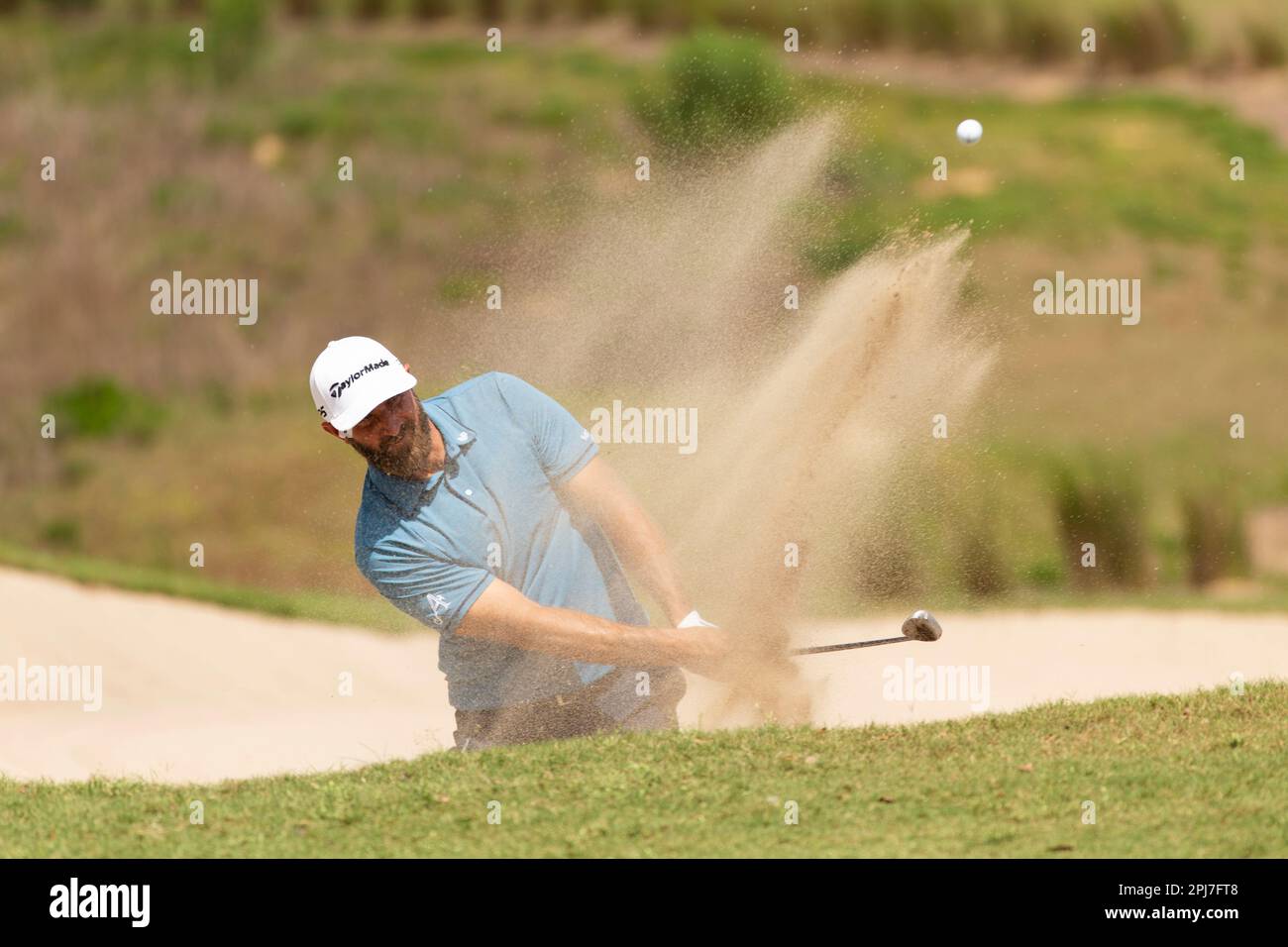 Captain Dustin Johnson of 4Aces GC hits out of a bunker during the ...