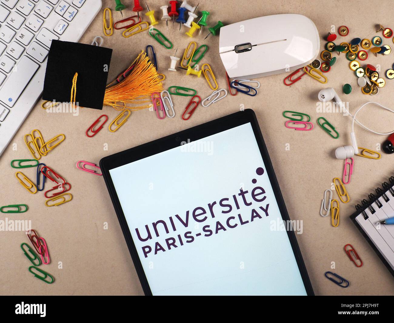 In this photo illustration, the Universit Paris-Saclay logo seen displayed on a tablet Stock ...