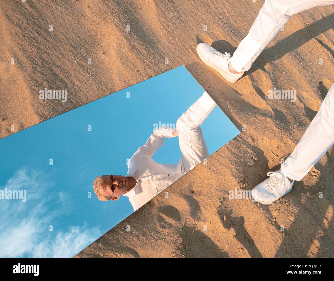 A man in white clothes in the desert. There's sand all around. Fantasy ...