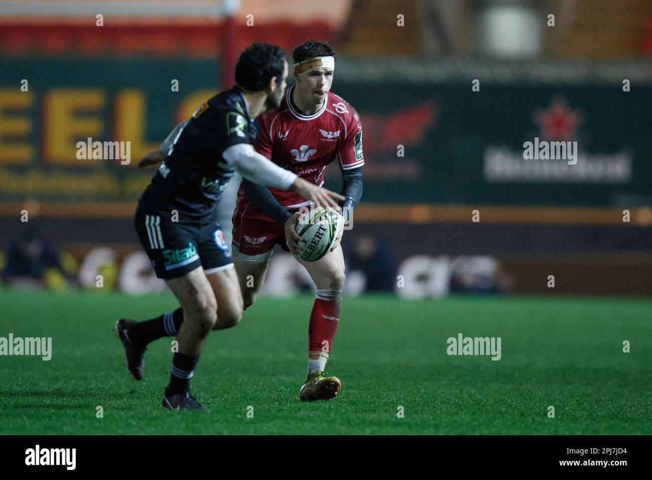 Llanelli, UK. 31 March, 2023. Tom Rogers of Scarlets takes on Tom Raffy ...