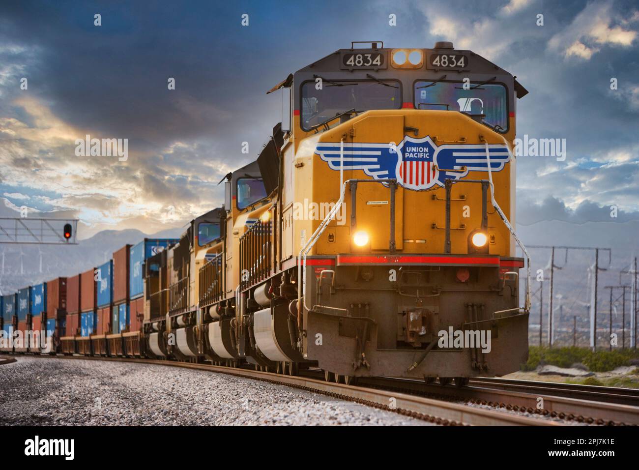 A union pacific Diesel locomotive pulling a string of container cars through Coachella valley in ...