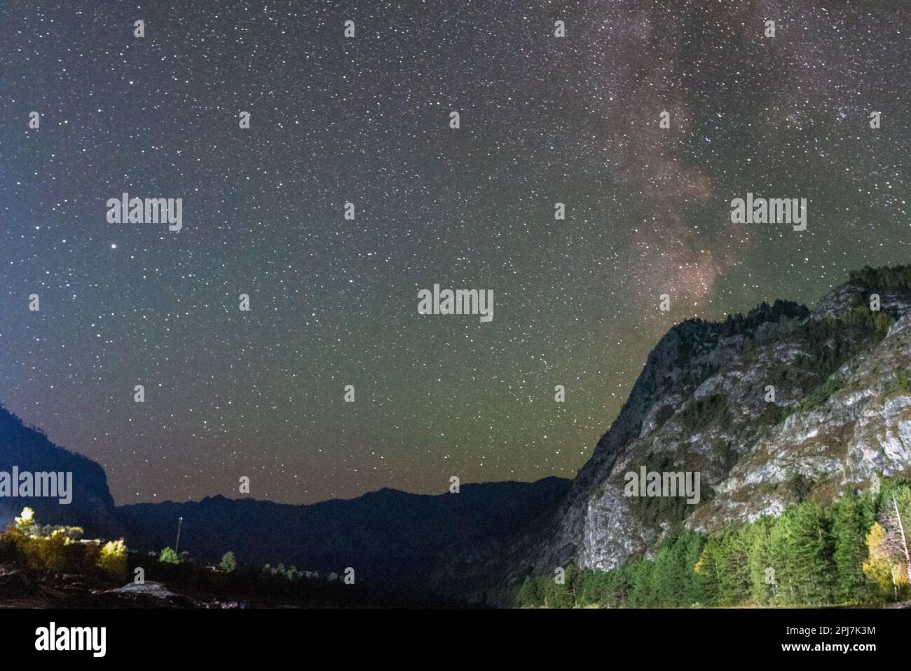 Starry bright night with milky way in the sky above a mountain and a ...