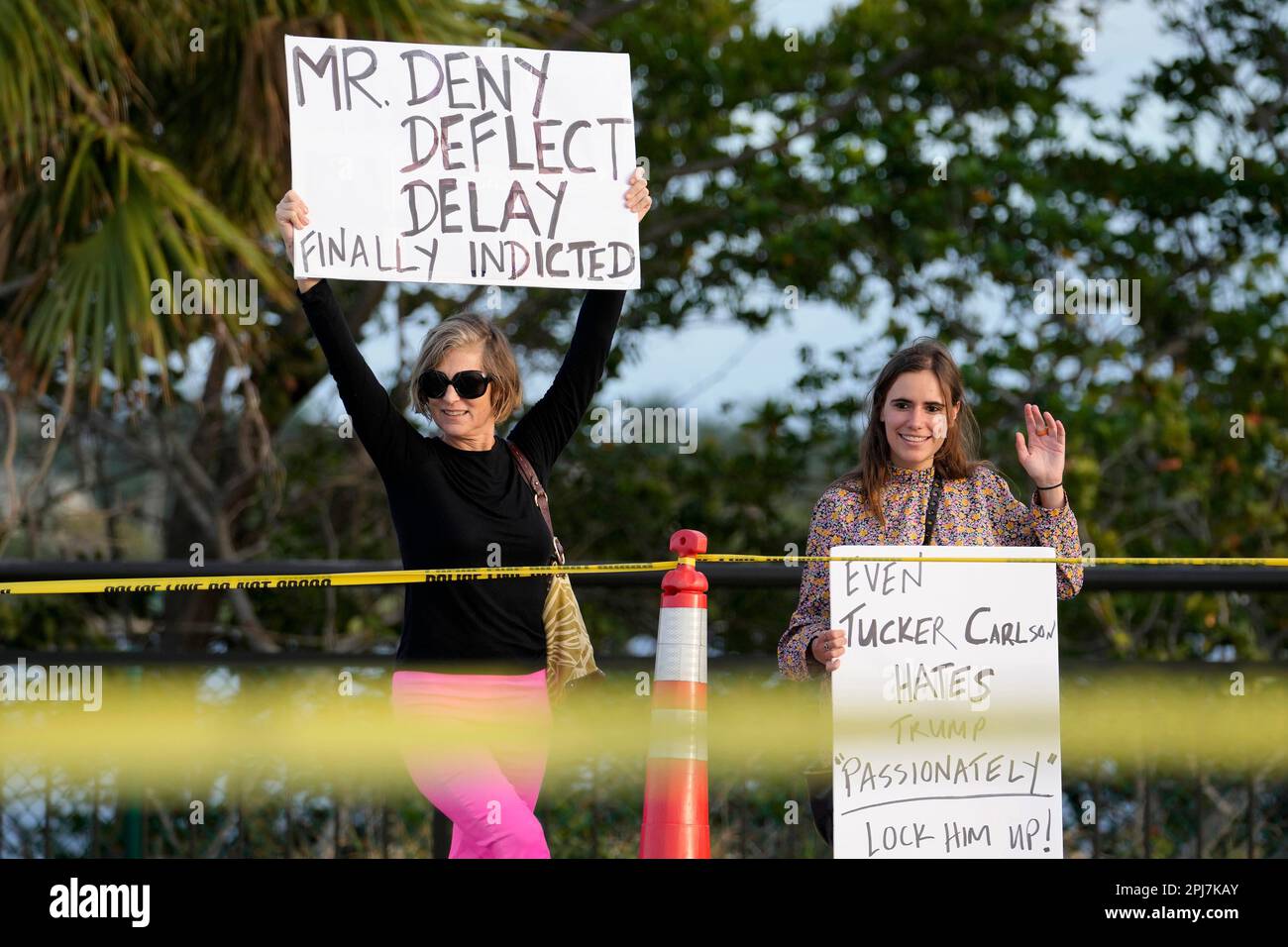 Victoria Doyle, left, and Fernanda Amis, right, holds signs in protest ...