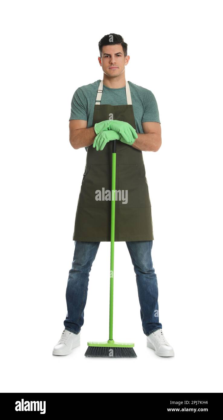 Man with green broom on white background Stock Photo - Alamy