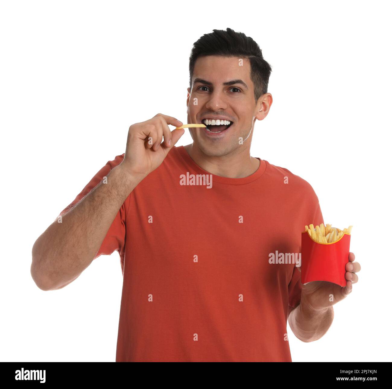 Man eating French fries on white background Stock Photo - Alamy