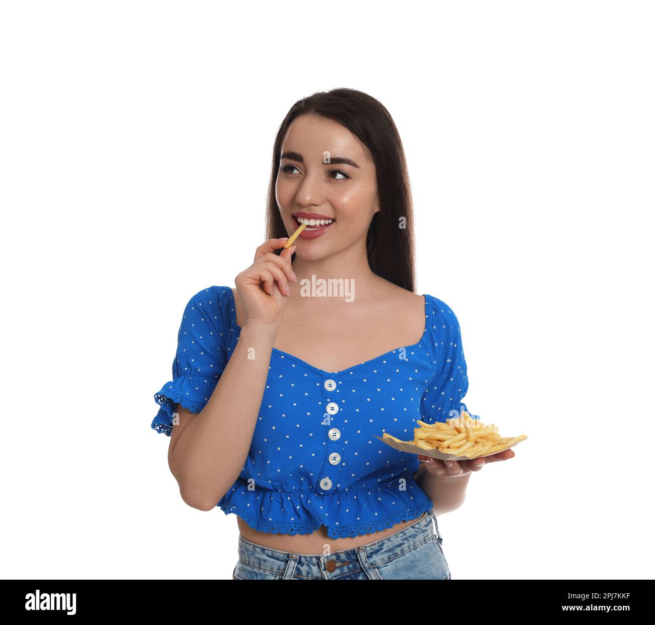 Beautiful young woman eating French fries on white background Stock ...