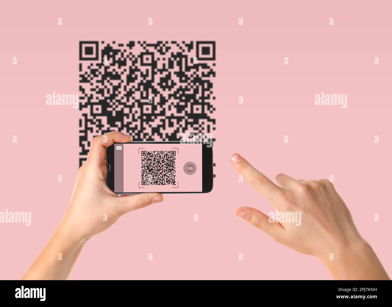 Woman scanning QR code with smartphone on pink background, closeup ...