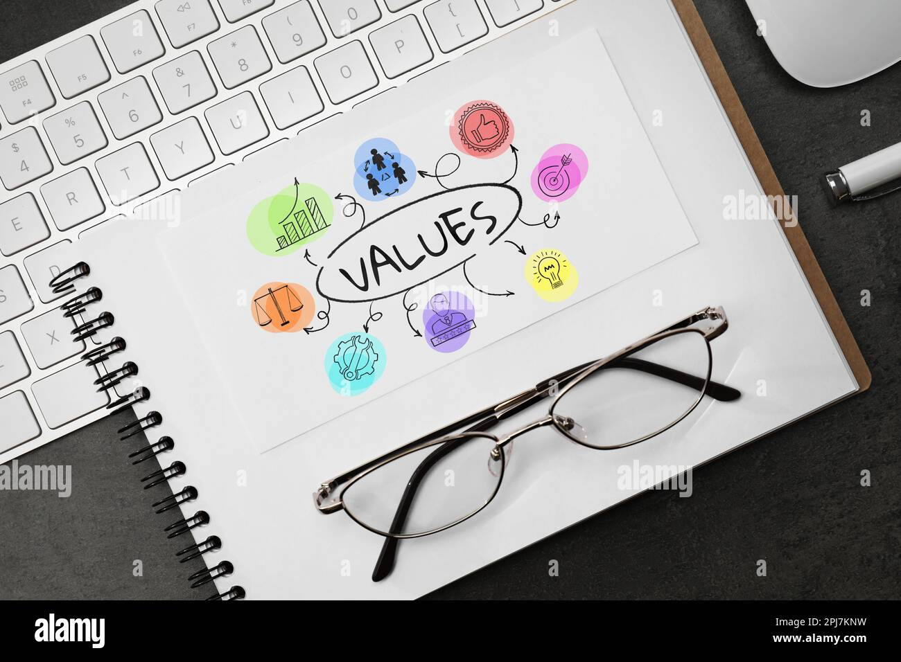 Concept of core values. Notebook with different images on black table ...