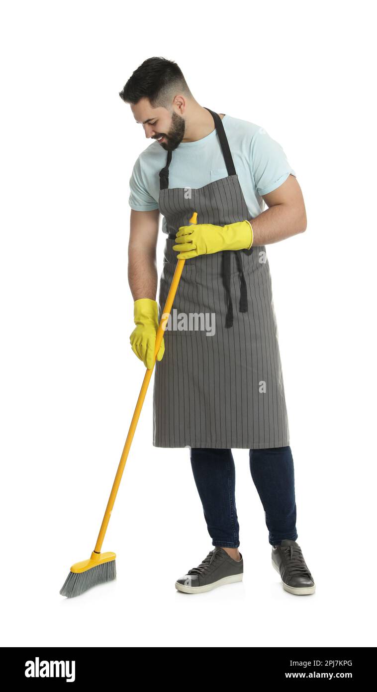 Young man with yellow broom on white background Stock Photo - Alamy