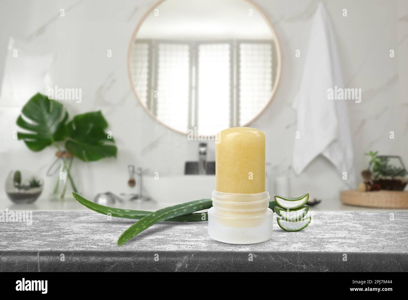 Natural crystal alum deodorant and aloe on grey table in bathroom Stock ...