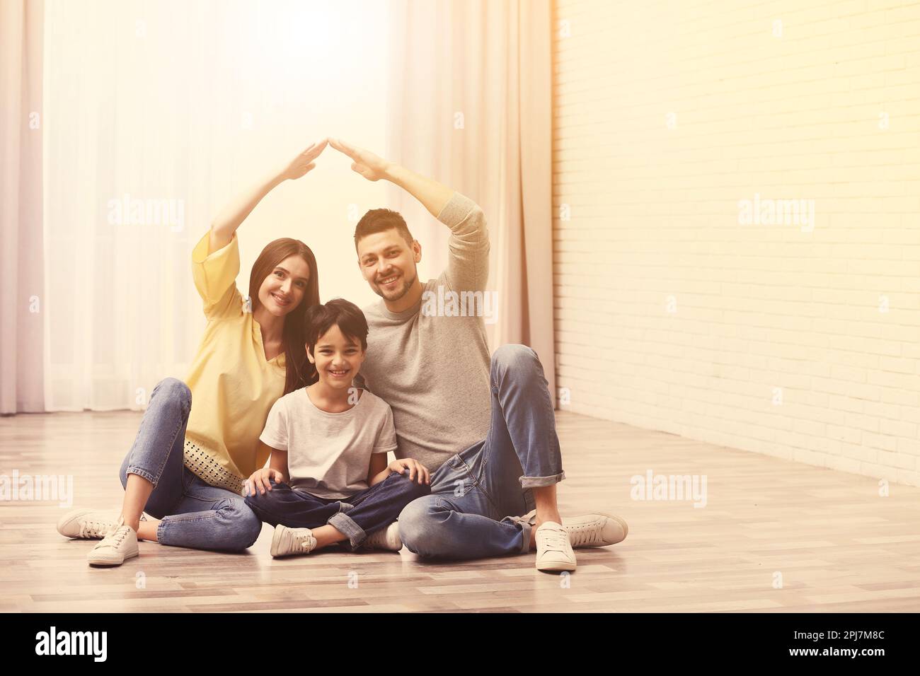 Happy family forming house roof with their hands at home. Insurance ...