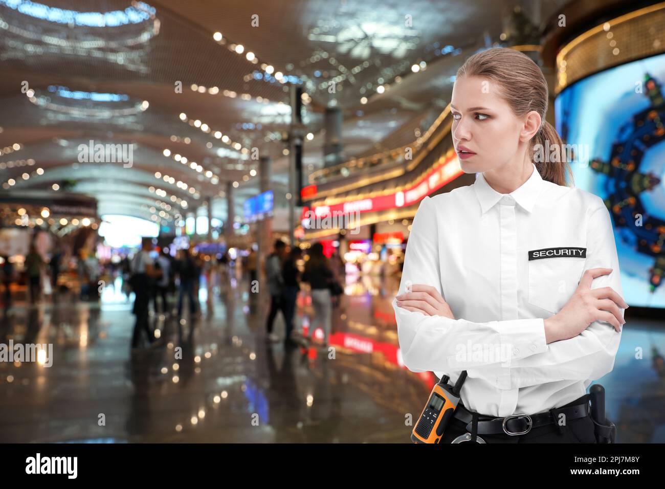 Female security guard wearing uniform in shopping mall Stock Photo - Alamy