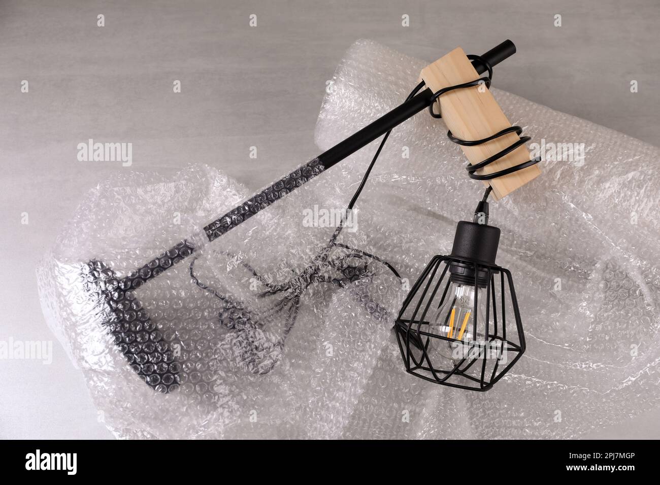 Beautiful lamp with bubble wrap light grey table Stock Photo - Alamy