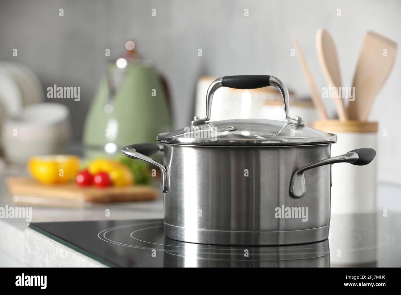 New shiny pot with glass lid in kitchen Stock Photo - Alamy