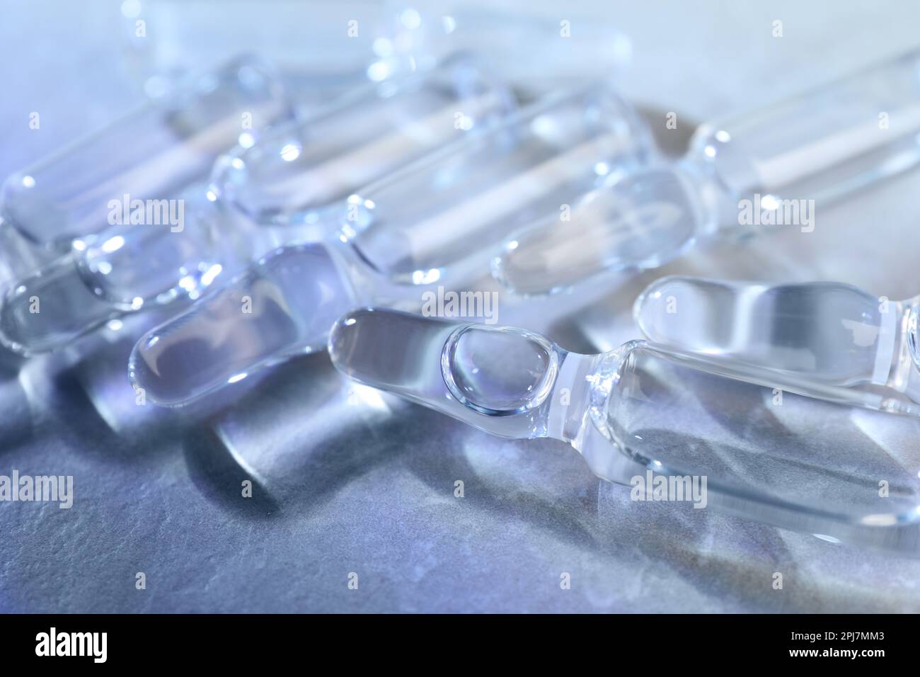 Pharmaceutical ampoules with medication on grey table, closeup Stock ...