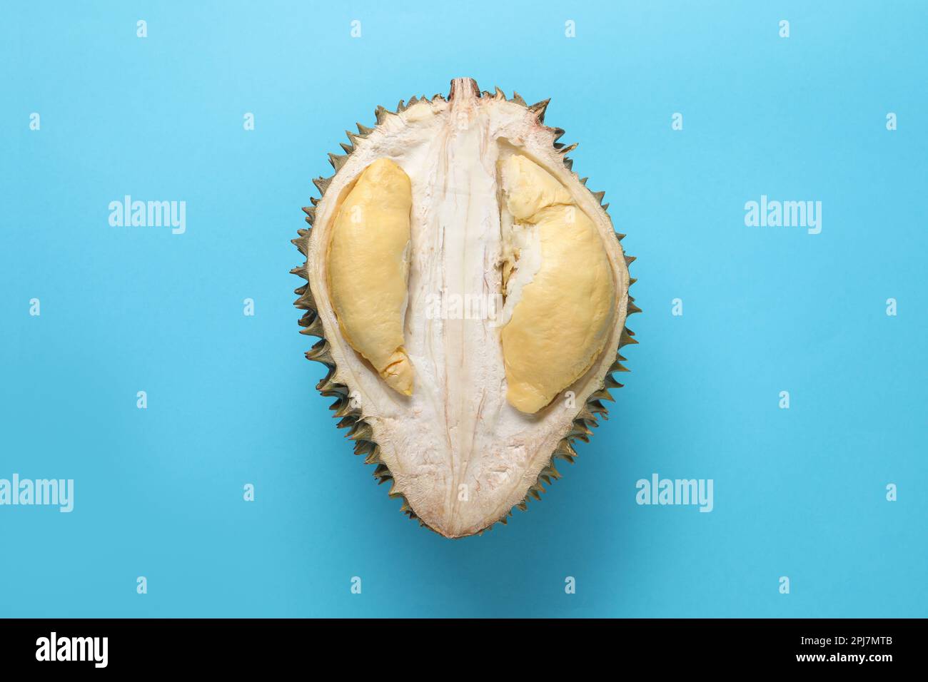 Half of fresh ripe durian on light blue background, top view Stock ...