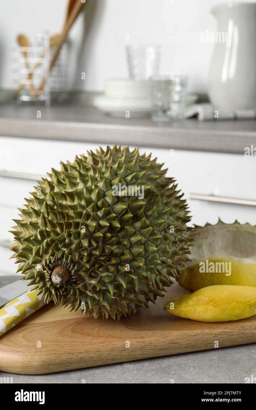 Fresh ripe durian fruits on grey table in kitchen, space for text Stock ...