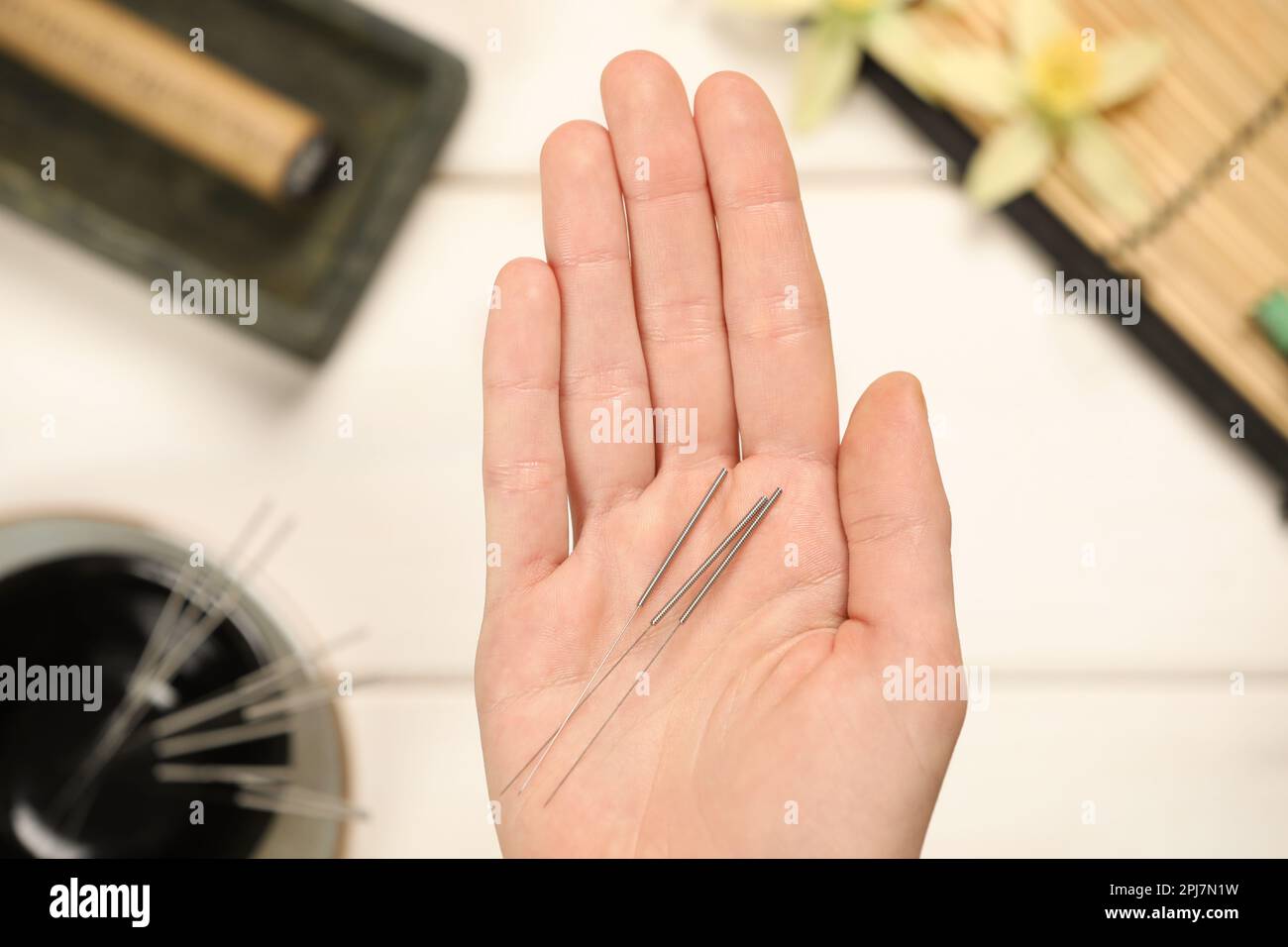Doctor holding acupuncture needles hi-res stock photography and images ...