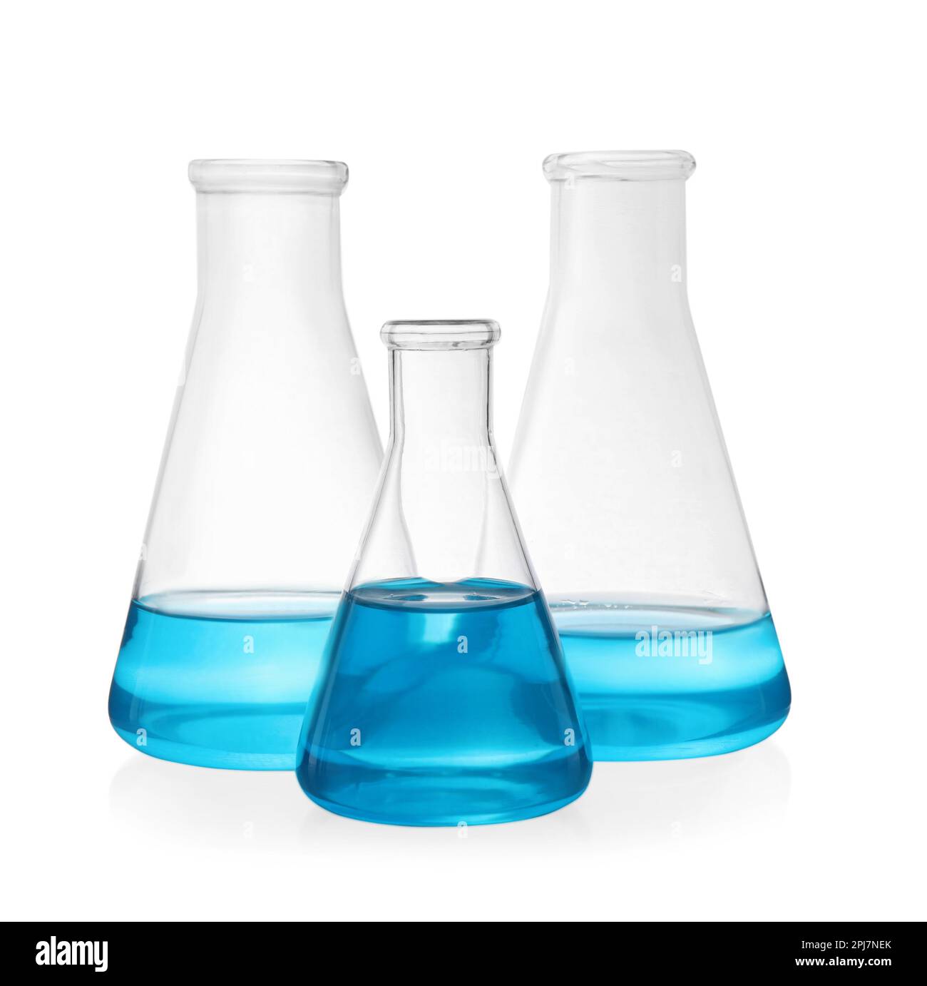 Different laboratory glassware with light blue liquid on white ...