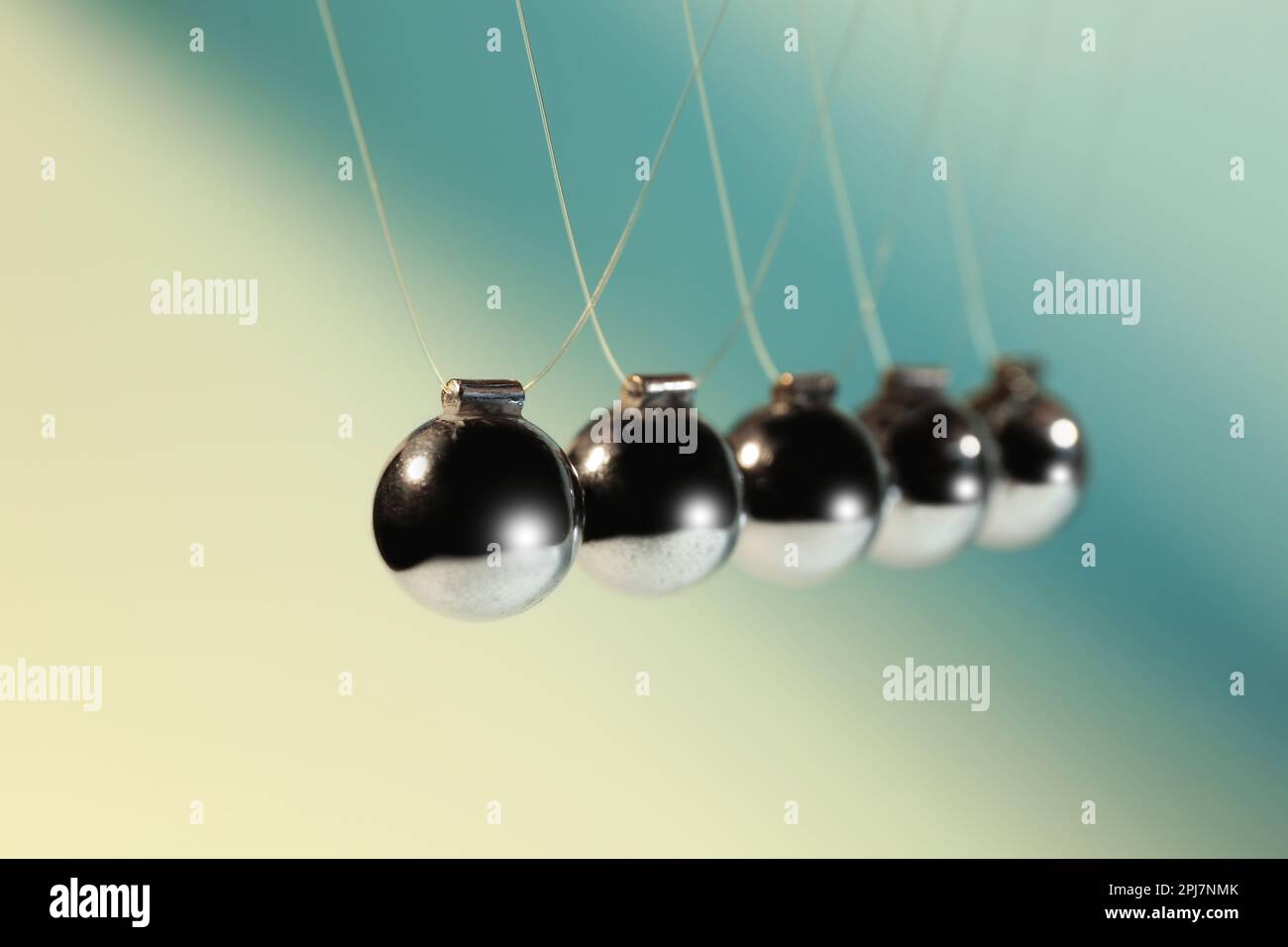 Newton's cradle on color background, closeup. Physics law of energy ...