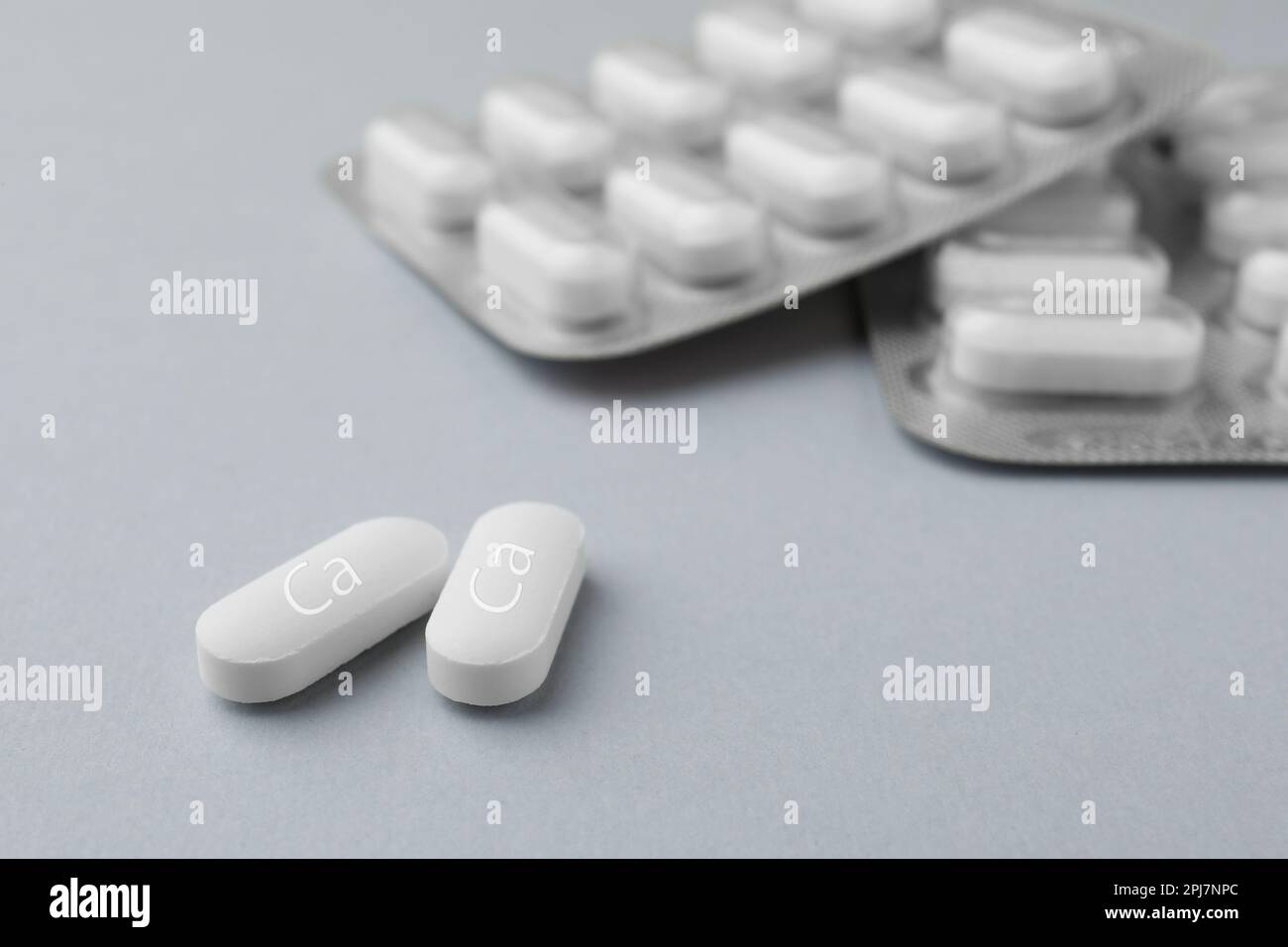 Calcium supplement pills on light grey background, closeup Stock Photo ...