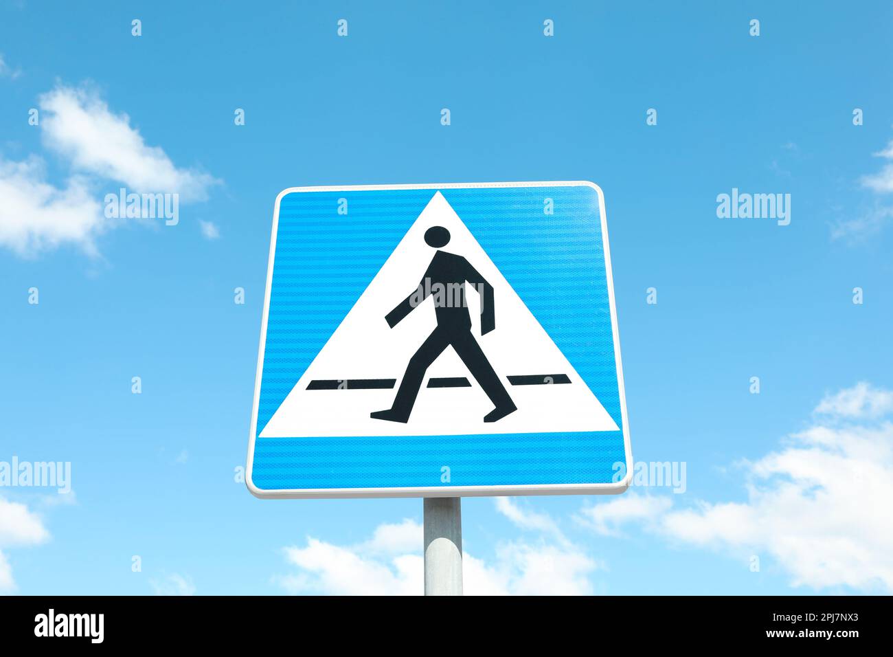 Traffic sign Pedestrian Crossing against blue sky, low angle view Stock ...
