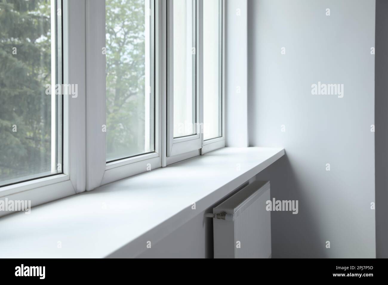 Modern office with window and radiator. Interior design Stock Photo - Alamy