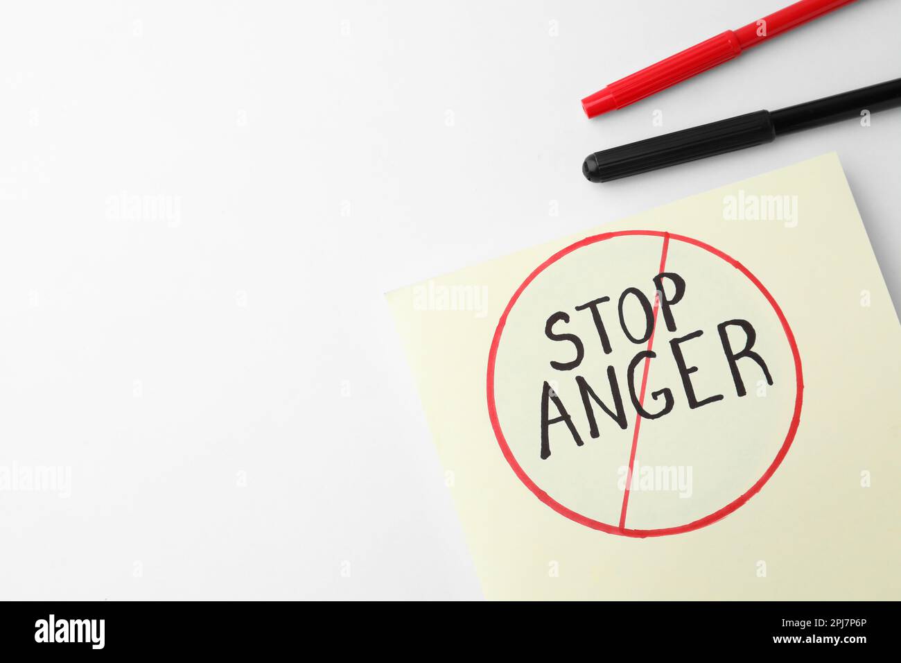 Black and red felt tip pens near sheet of paper with crossed over ...