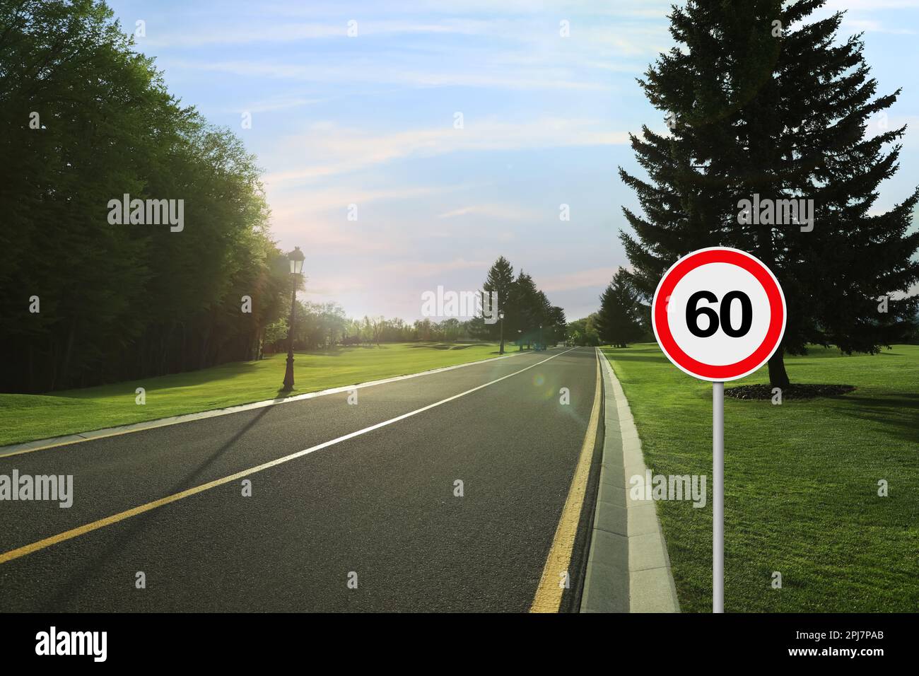 Traffic sign MAXIMUM SPEED 60 near empty asphalt road on sunny day ...