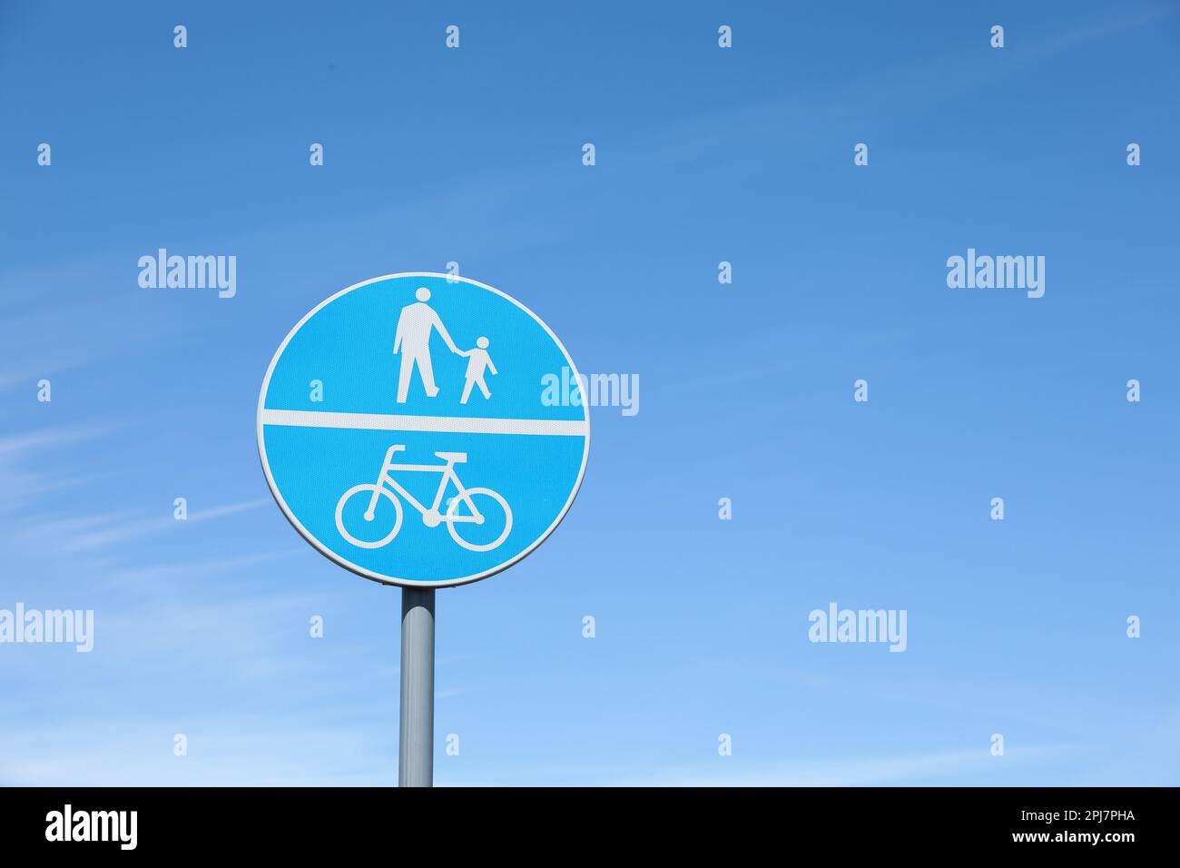 Traffic sign Compulsory Track For Pedestrians and Bicycles against blue ...