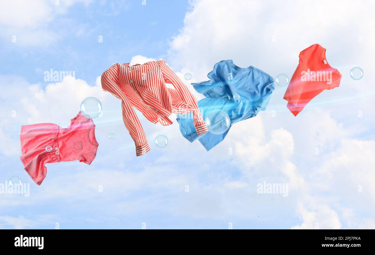 Washing powder bubbles and clothes flying in blue cloudy sky Stock ...
