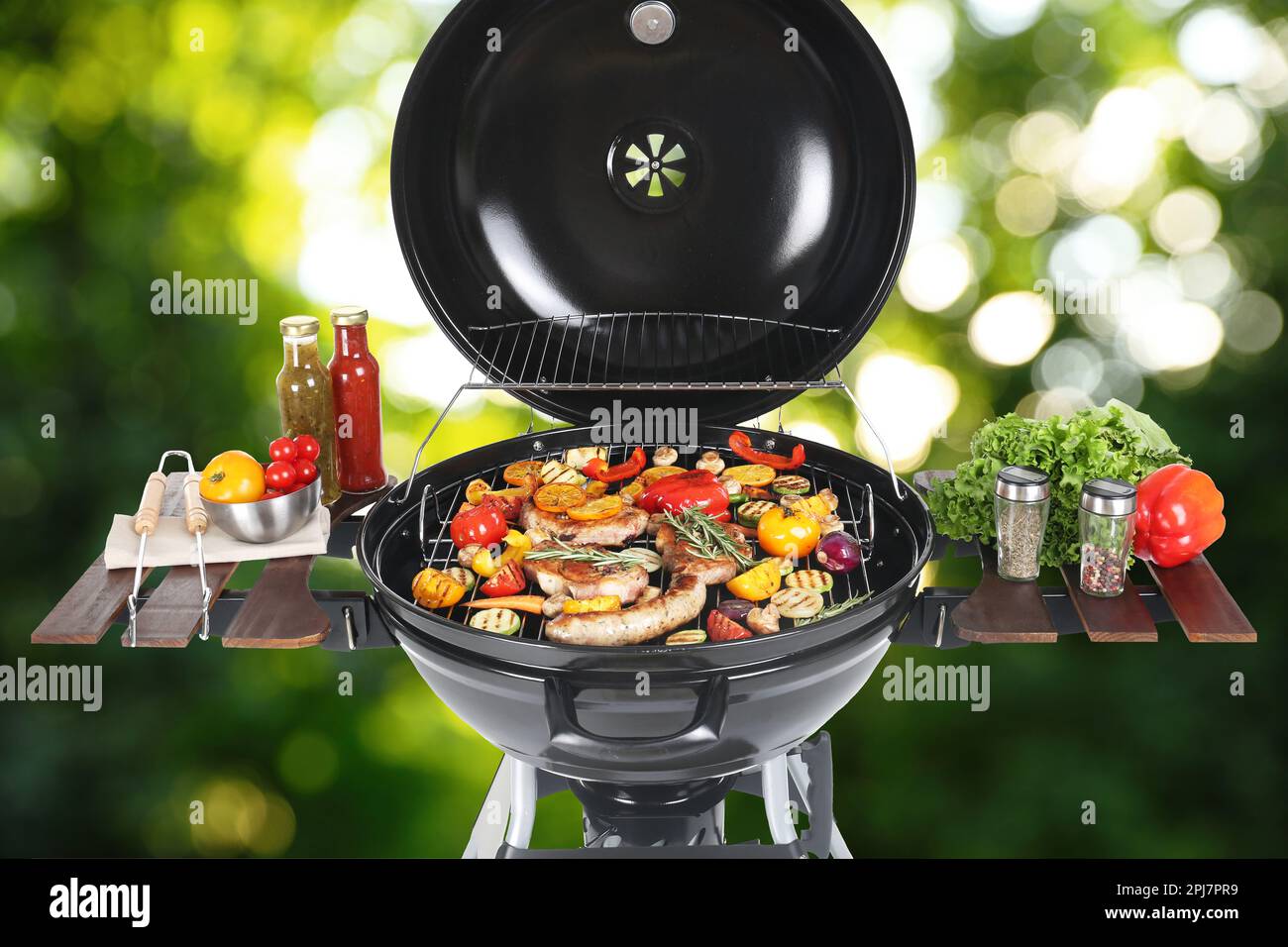 Modern barbecue grill with tasty food outdoors on sunny day Stock Photo ...