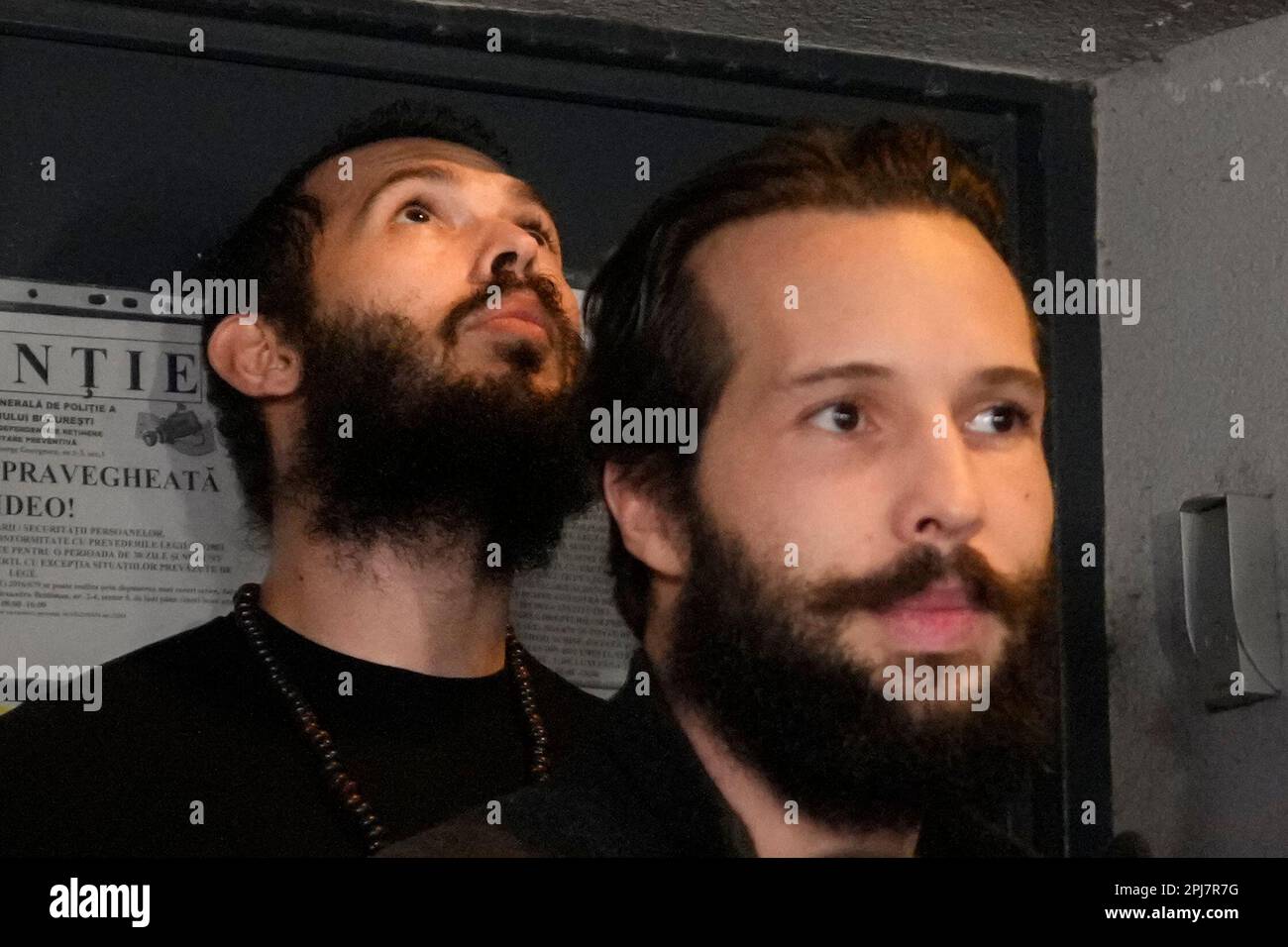 Andrew Tate looks up upon exiting a police detention facility in ...