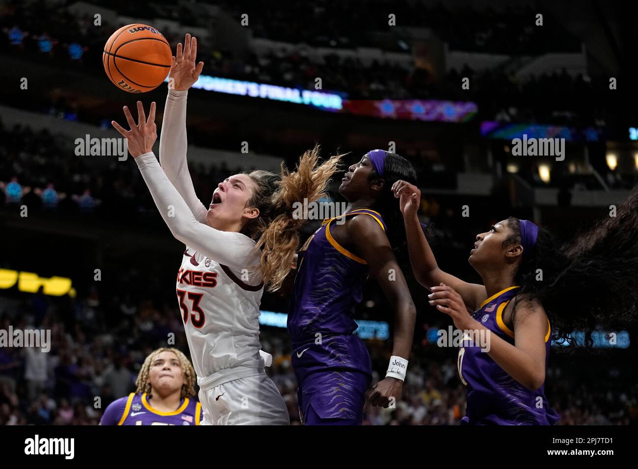 Virginia Tech's Elizabeth Kitley is fouled as she shoots past LSU's ...