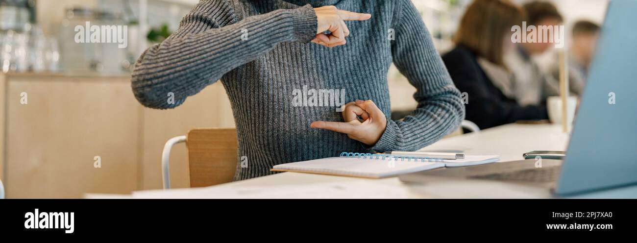 Smiling african woman speaks sign language with friends by video call ...