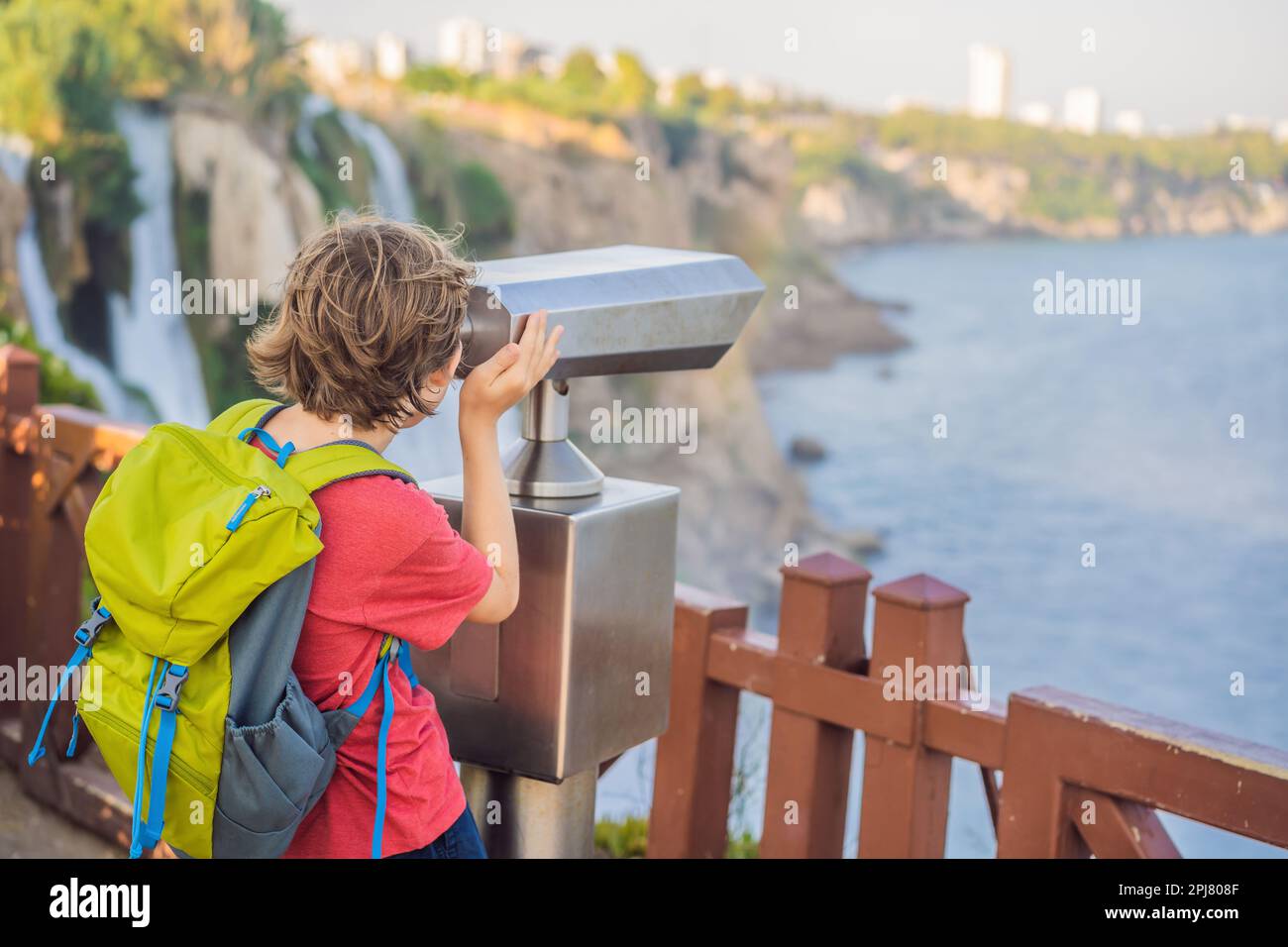 Boy tourist with a backpack on the background of Duden waterfall in ...