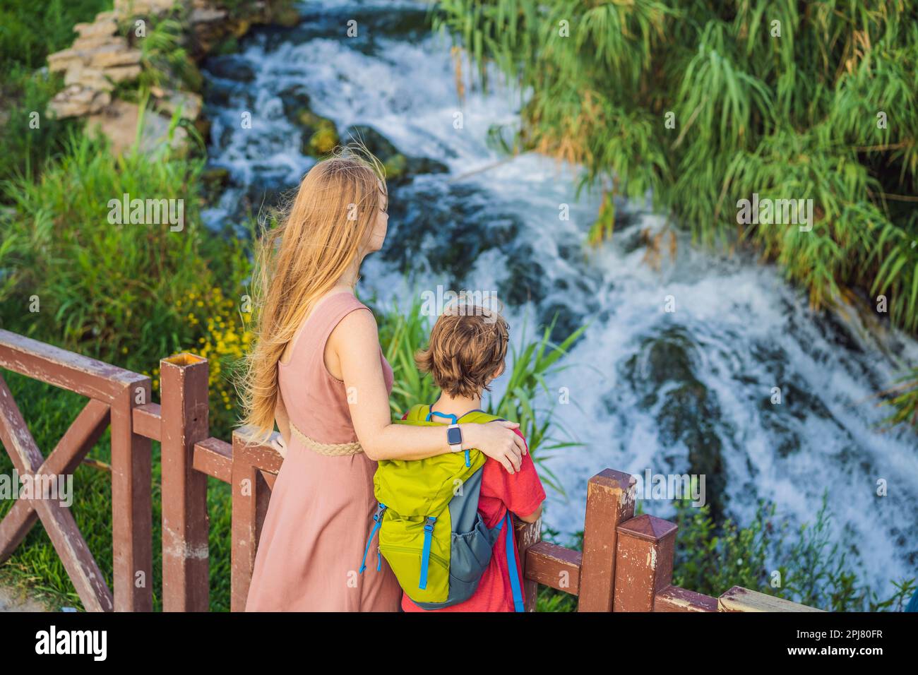 Mother and son tourists on the background of Duden waterfall in Antalya ...