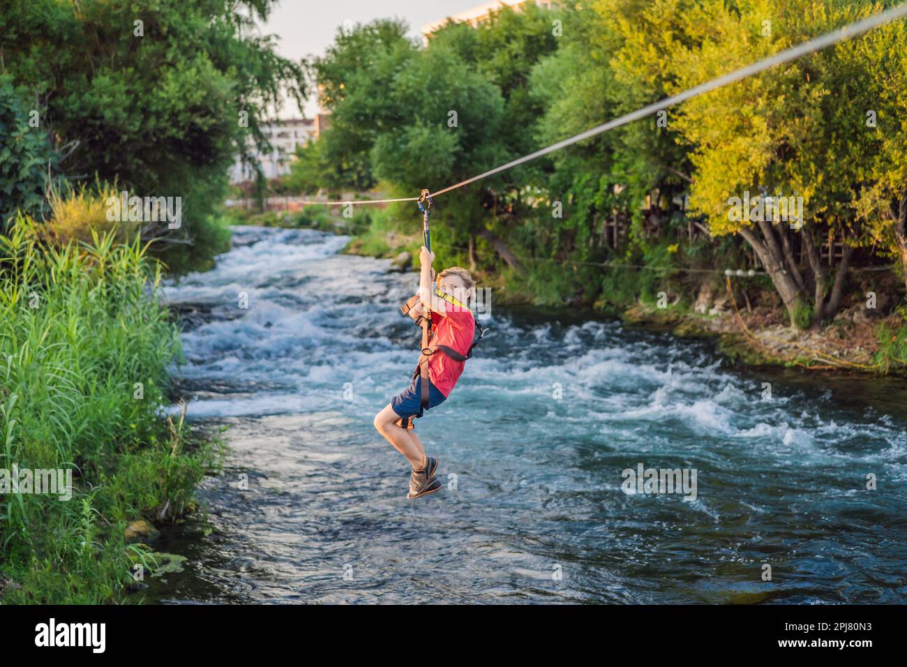 Kid Zipline, Zipline Over the River. Kid Adventure Stock Photo - Alamy