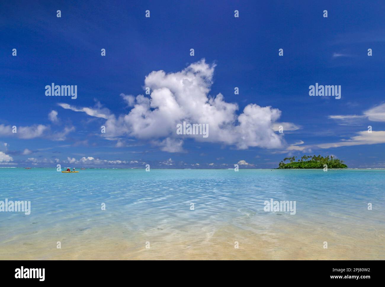 Kayakers and the palm tree covered tropical island of Motu Taakoka in ...