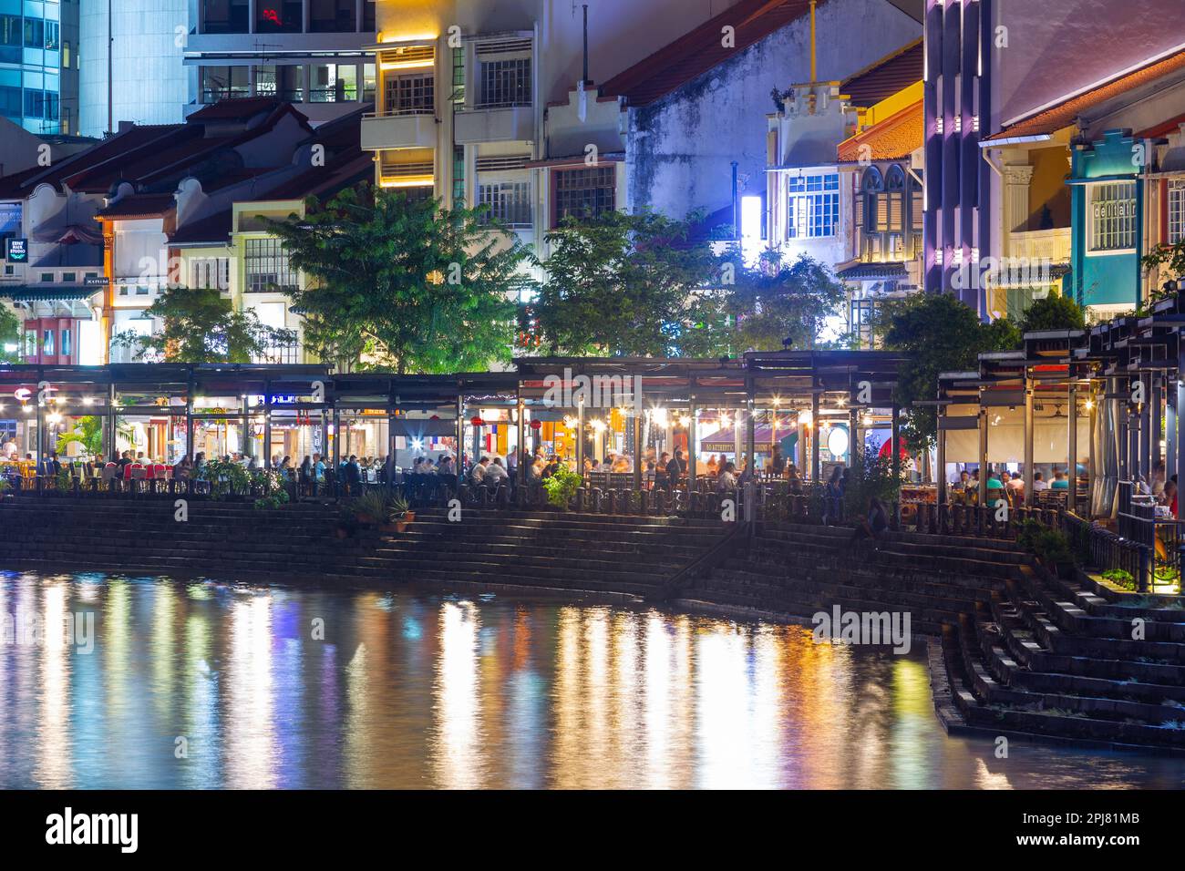 A night view of the Boat Quay on the Singapore River in Singapore. The ...