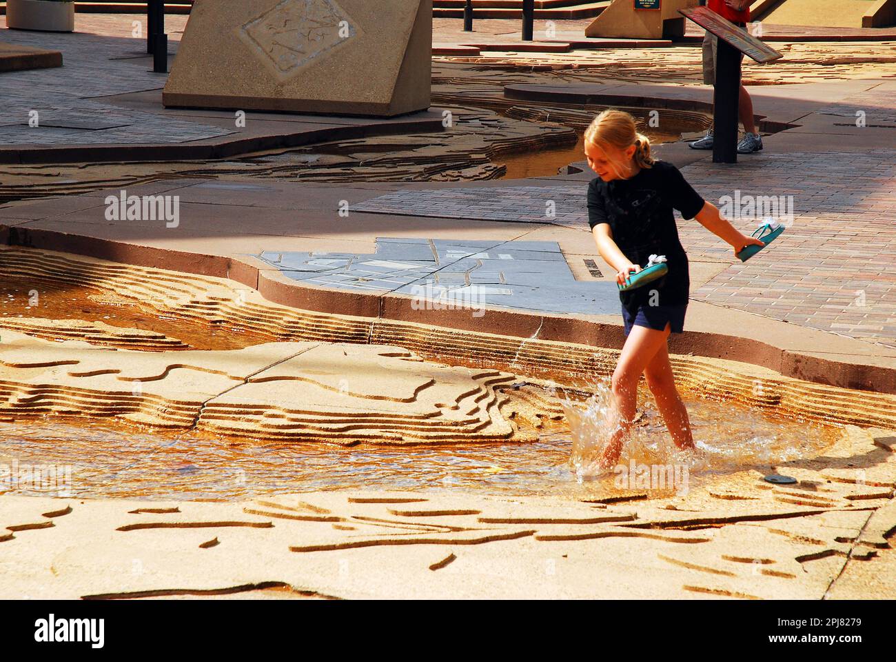 A young girl wades in a scale model of the Mississippi River at Mud ...